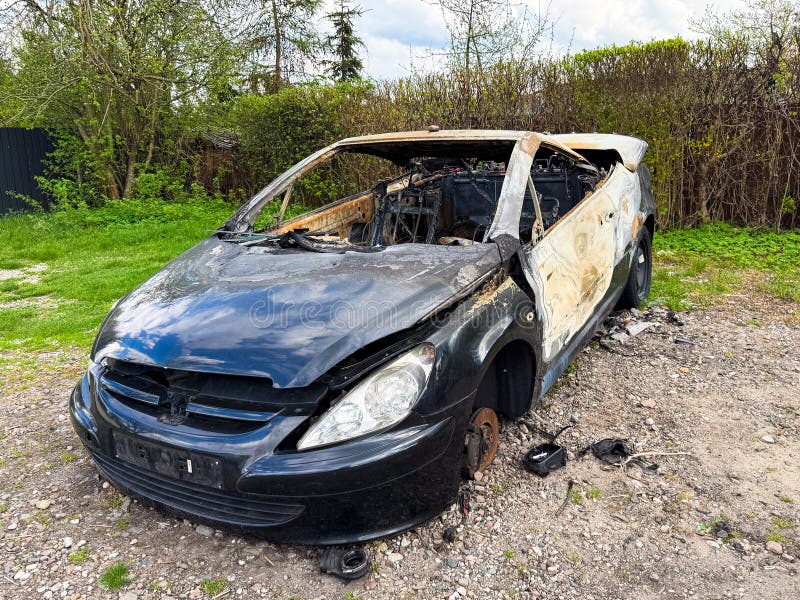 Severely Burned Black Car with Missing Wheels and Extensive Fire Damage ...