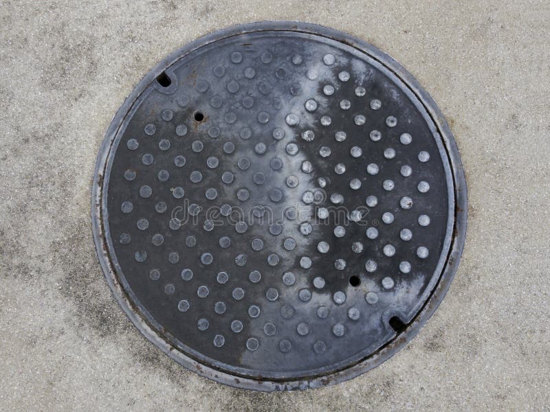 Sewer cover in the street. stock image. Image of flowing - 76264439