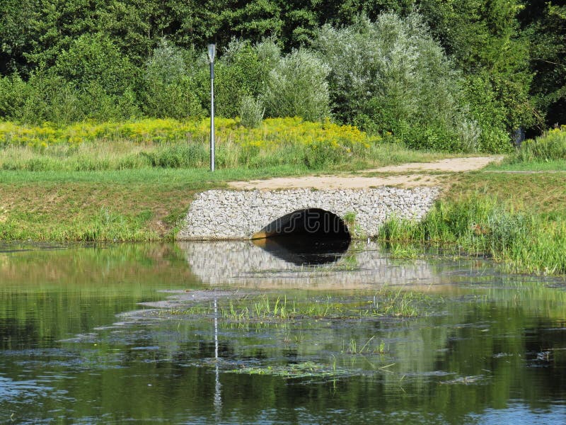 Sewer Drain Manhole Culvert Reflection on Water Surface Stock Photo ...