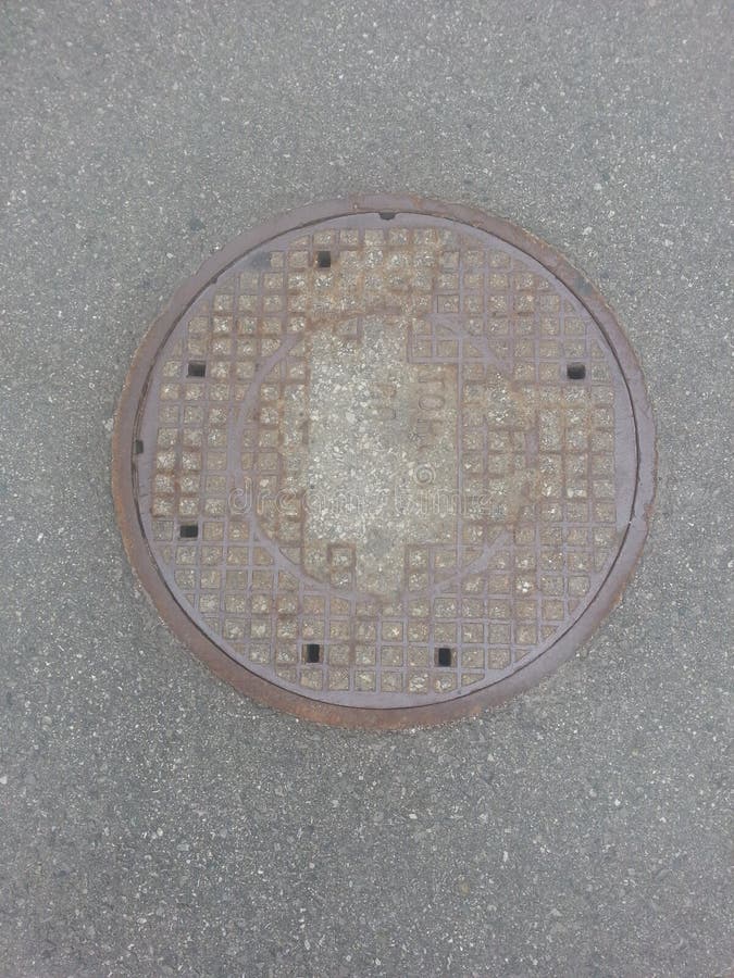 Manhole Cover Ashphalt stock photo. Image of rust, asphalt - 45393460