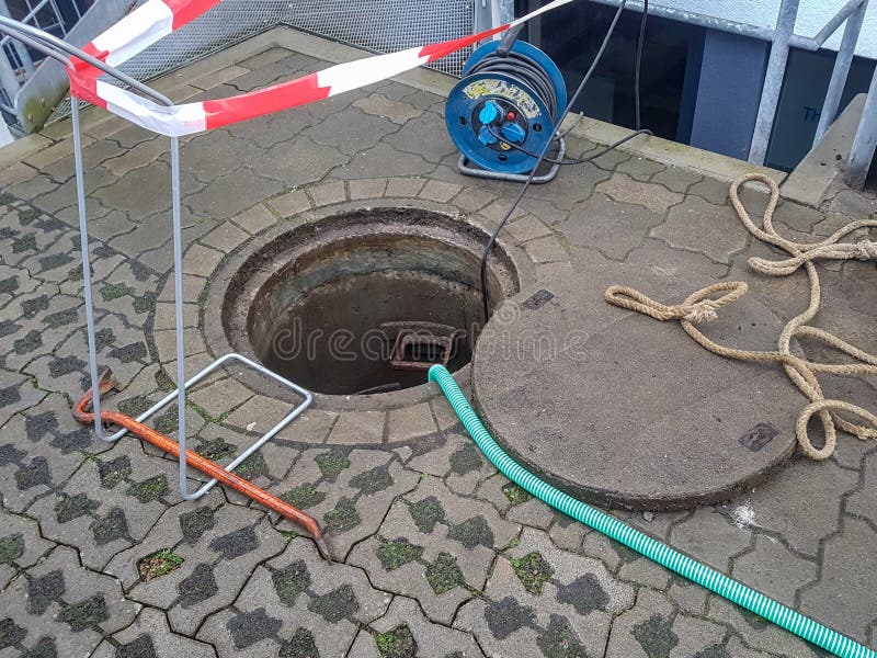 Working in a Manhole from Above Stock Photo - Image of aspirate ...