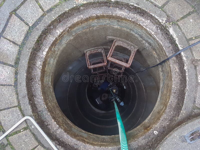 Working in a Manhole from Above Stock Image - Image of construction ...