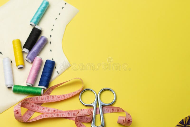 Sewing Accessories and Fabric on a Yelow Background. Sewing Threads ...