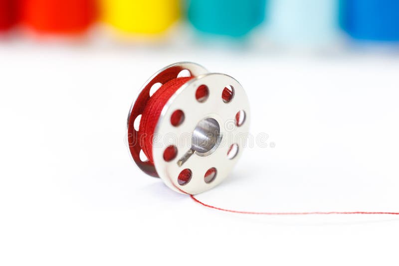 Sewing Bobbin and Row of Spools of Thread Stock Photo - Image of ...