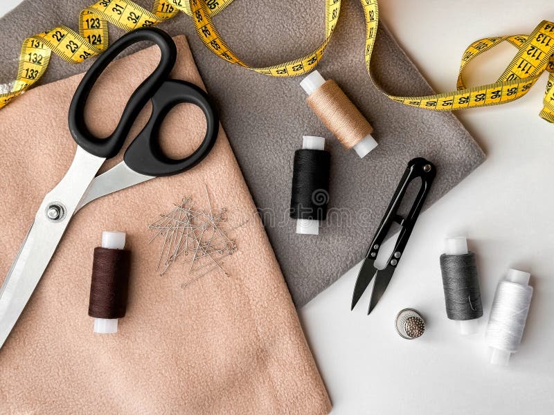 Sewing Essentials with Scissors, Measuring Tape, and Thread on Fabric ...