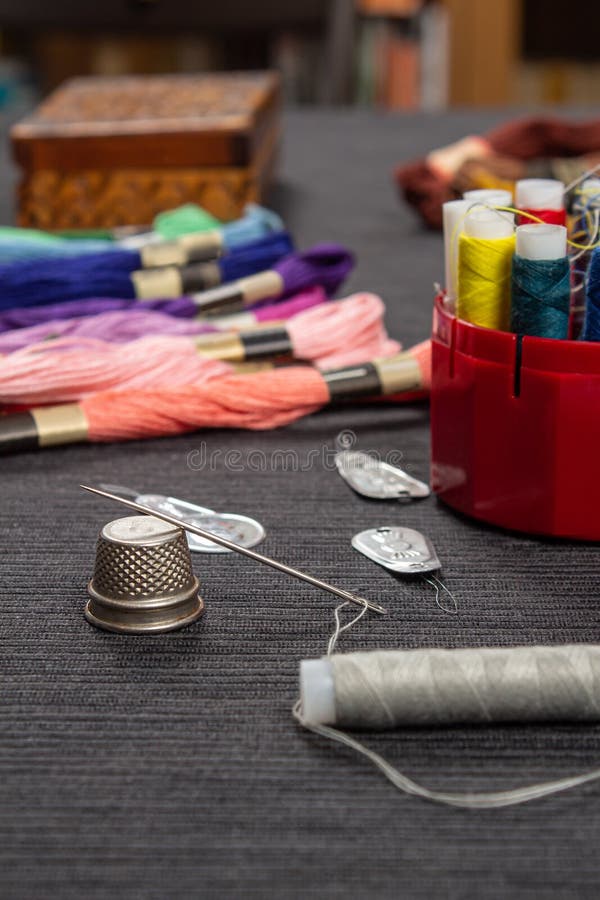 The Sewing Items are on the Table. the Thread is Threaded Over the ...