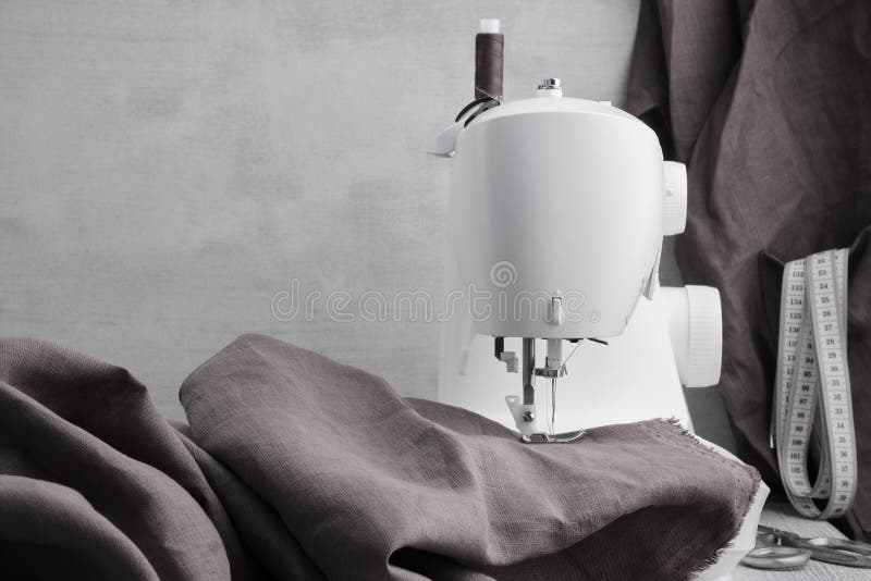 Sewing Linen Clothes on a Sewing Machine. in the Background is a ...