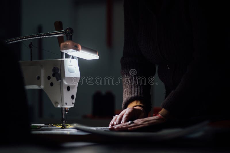 Sewing machine in dark stock image. Image of light, factory - 131546577