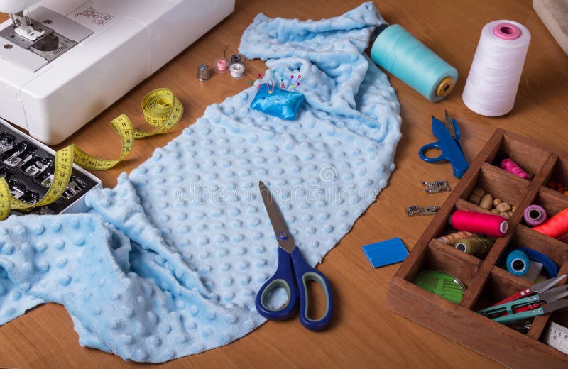 Sewing Machine, Drawer with Accessories, Piece of Light Blue Cloth and ...