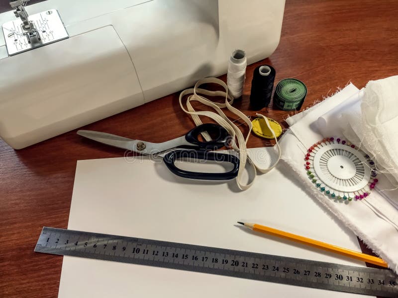 Sewing Materials Lie on the Brown Surface of the Table. Ruler, Pencil ...
