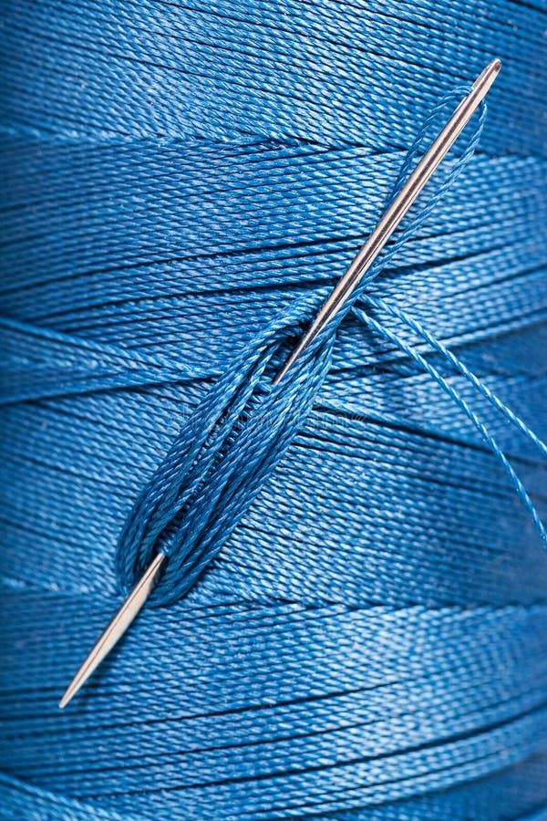 Sewing Needle In Blue Thread Spool Stock Photo - Image of clothing ...