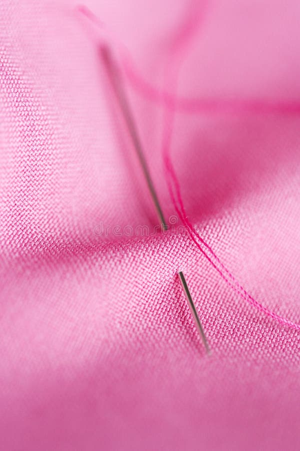 Sewing Needle with Thread Stuck into Pink Fabric Stock Photo - Image of ...
