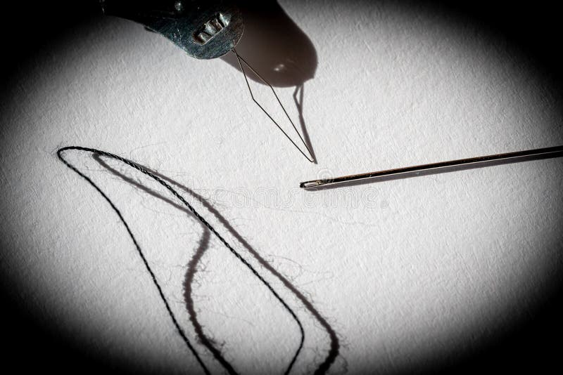 Sewing Needle Threader Tool in Use and a Single Black String. Stock ...