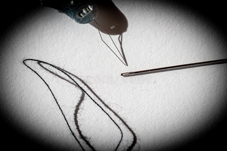 Sewing Needle Threader Tool in Use and a Single Black String. Stock ...