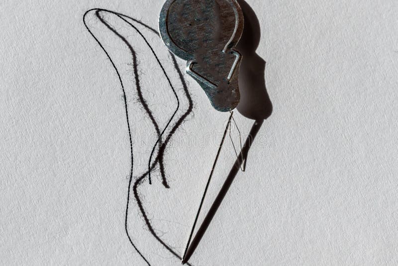 Sewing Needle Threader Tool in Use and a Single Black String. Stock ...