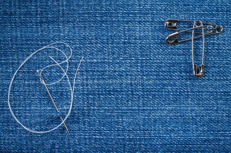 Sewing Needle with a White Thread and Three Pins on a Denim with Copy ...