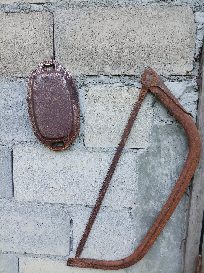 Sewing with Old Rusted Trays Hanging on Brick Walls Background. Stock ...