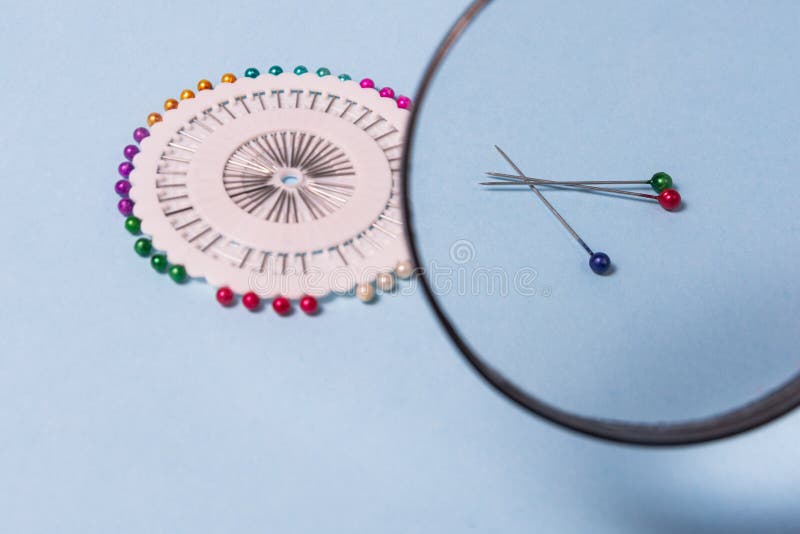 Sewing Pins with Multi-colored Heads are on a Blue Background. we Look ...
