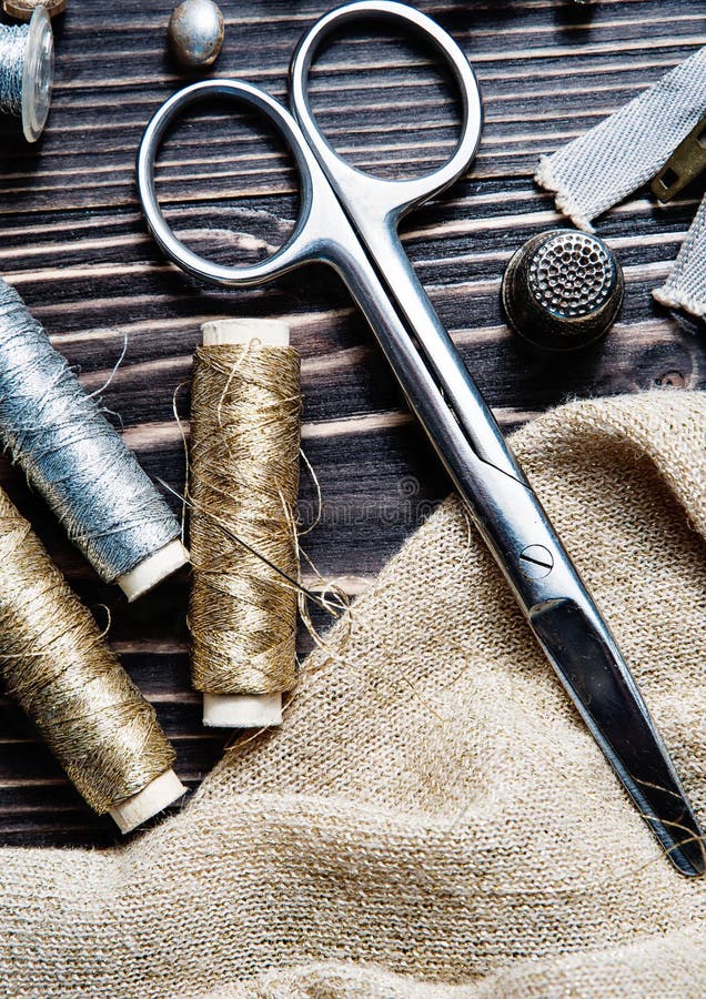 Sewing Textile or Cloth. Scissors Reel of Thread, and Golden Fabric ...