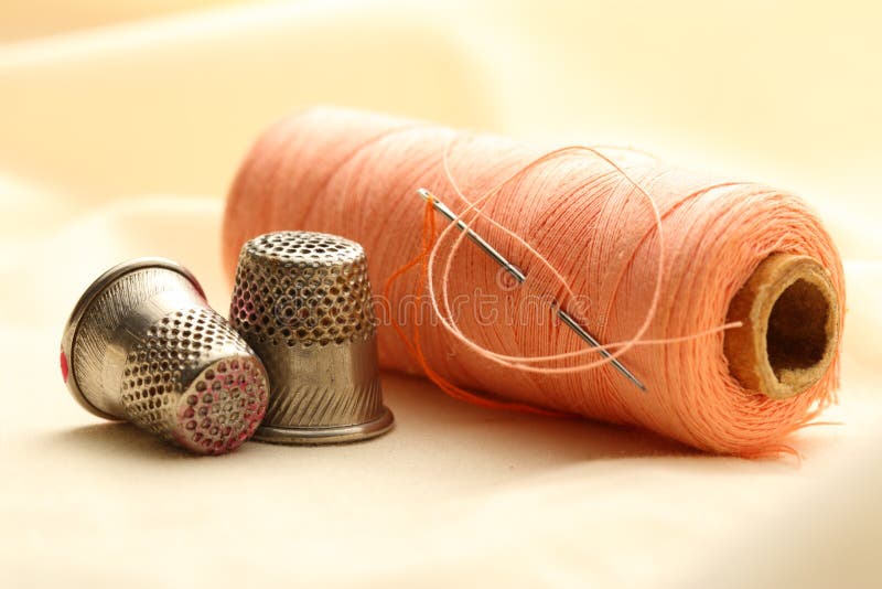 Sewing Thimbles, Bobbin and Needle Stock Photo - Image of orange, craft ...