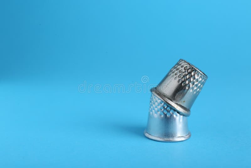Sewing Thimbles on Light Blue Background, Closeup. Space for Text Stock ...