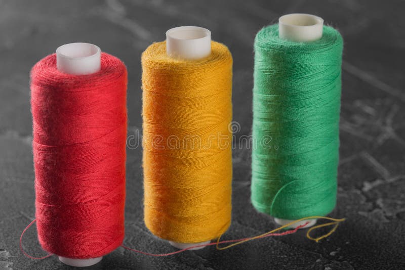 Sewing Thread in Different Color on the Plastic Coil. Object on a Gray ...