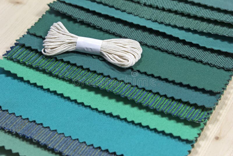 Sewing Thread Lies on Different Fabric Patterns Stock Photo - Image of ...