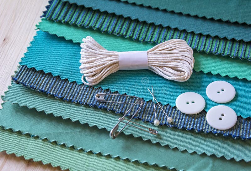 Sewing Thread Lies on Different Fabric Patterns Stock Image - Image of ...