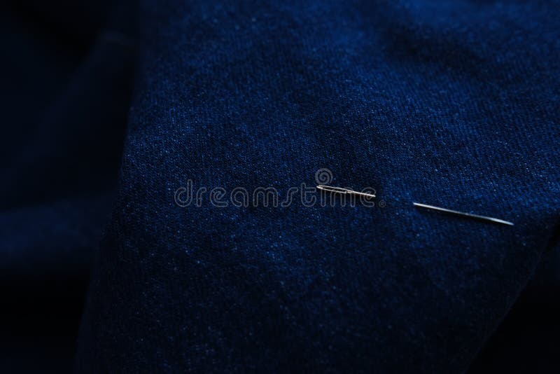 Sewing Thread and Needle at Jeans Denim Background Texture. Tailor ...