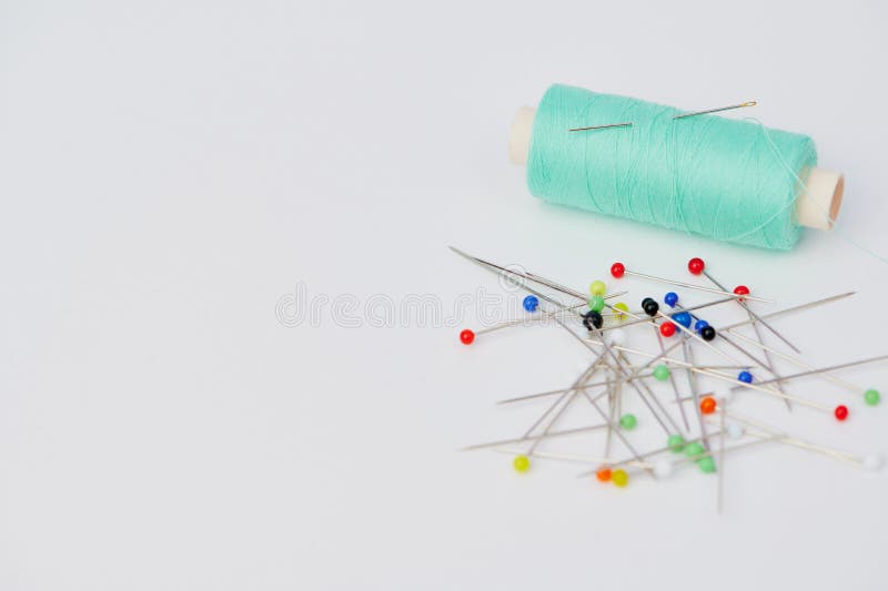 Sewing Thread and Pins on White Background with Copy Space Stock Photo ...