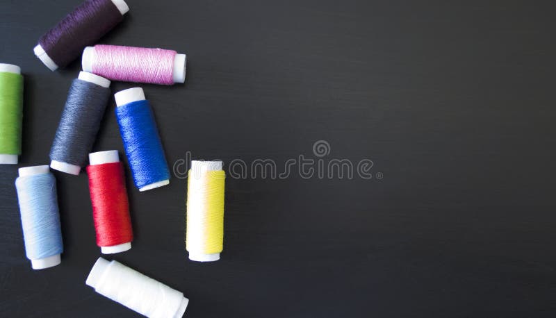 Sewing Threads on a Dark Wood Background, Multi Colored Thread, Sewing ...