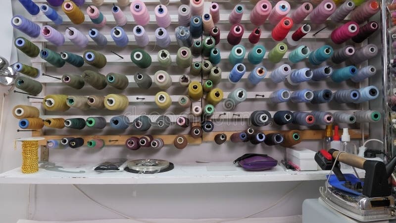 Set of Colored Threads for Sewing on Reels on the Wall in the Sewing ...