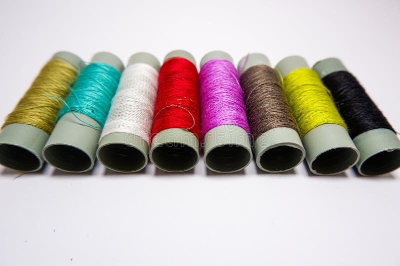 Sewing Threads of Different Colors on White Background. Stock Photo ...