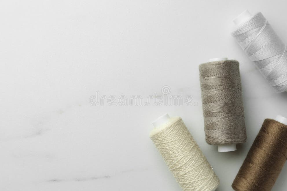 Sewing Threads on White Marble Table, Flat Lay. Space for Text Stock ...