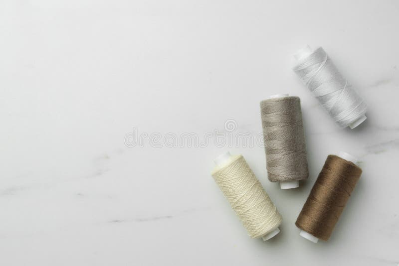 Sewing Threads on White Marble Table, Flat Lay. Space for Text Stock ...