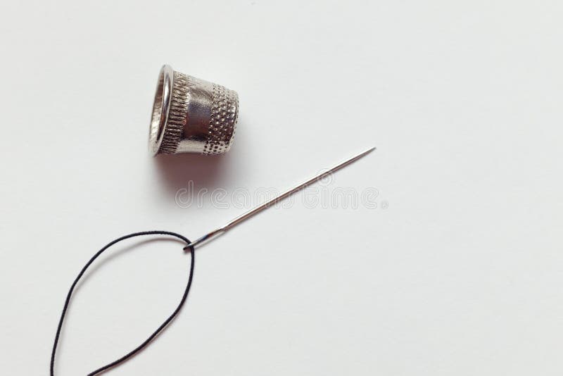Sewing Tools on White Fabric Background.Needle, Thread, Thimble and ...