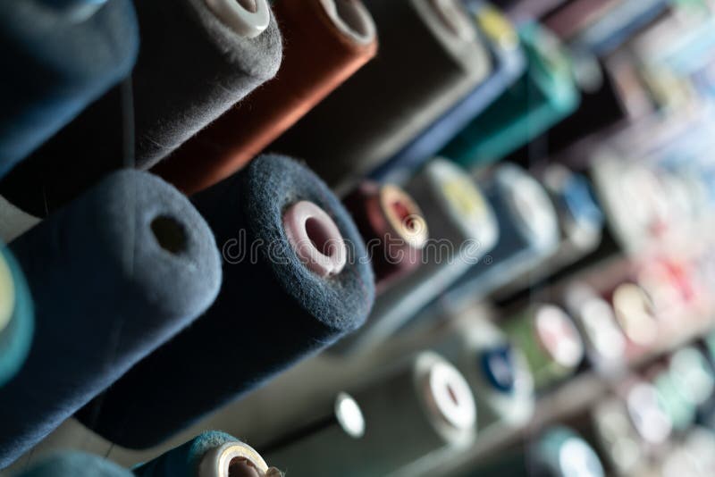 In a Sewing Workshop Many Spools of Thread of Different Colors Hang on ...