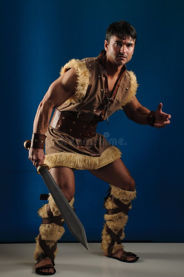 The Gladiator Strikes a Unique Pose Stock Photo - Image of heartthrob ...