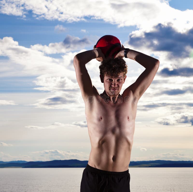 Male with Red Ball on the Beach Stock Image - Image of ball ...