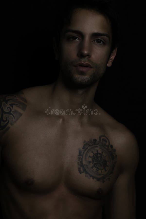 A Muscular Tattooed Man Over Dark Background. Stock Image - Image of ...