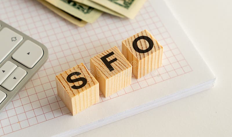 SFO Text on Wooden Cubes with Banknotes and Keyboard on an Open Notepad ...