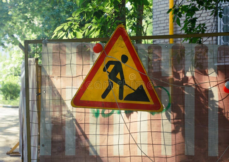 Shabby Road Sign with Digging Man. Shot with a Backlight Stock Image ...