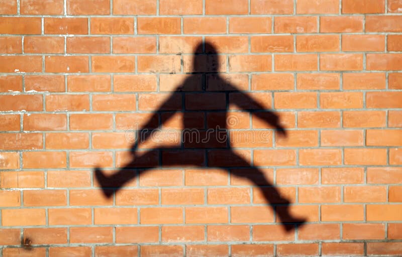 Shadow of Active Jumping Boy on Brick Wall Stock Image - Image of ...
