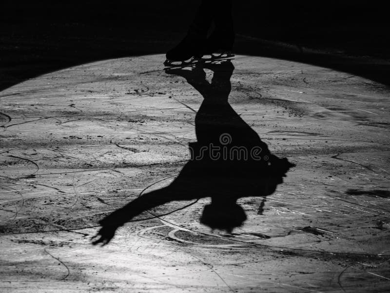Shadow of an Athlete Skater Reflected on the Ice Rink during the ...