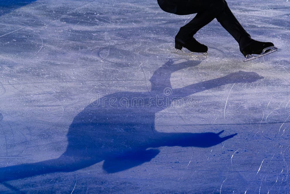 Shadow of an Athlete Skater Reflected on the Ice Rink during the ...