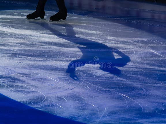 Shadow of an Athlete Skater Reflected on the Ice Rink during the ...