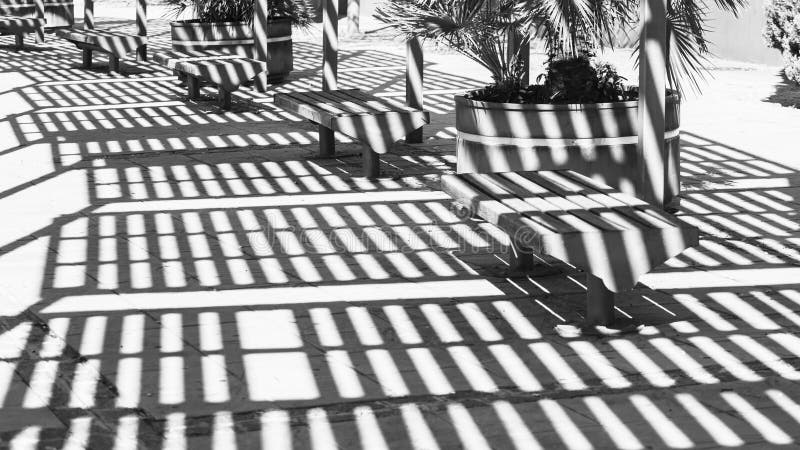 Shadow of Bars Over Some Benches Stock Photo - Image of shadows, bars ...