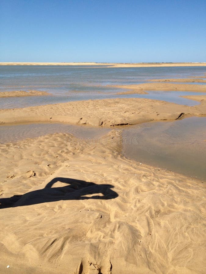 Shadow on the beach stock photo. Image of sand, holiday - 53615926