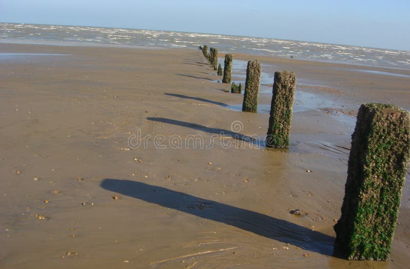 Shadow beach poles stock photo. Image of decaying, seascapes - 285134948
