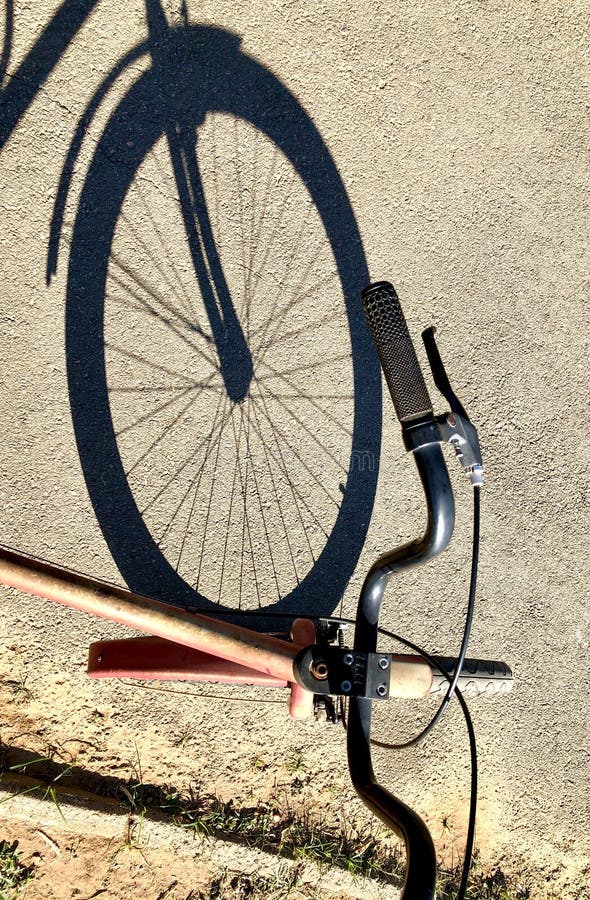 The Shadow of the Bicycle Tire Stock Photo - Image of gutter, wheel ...